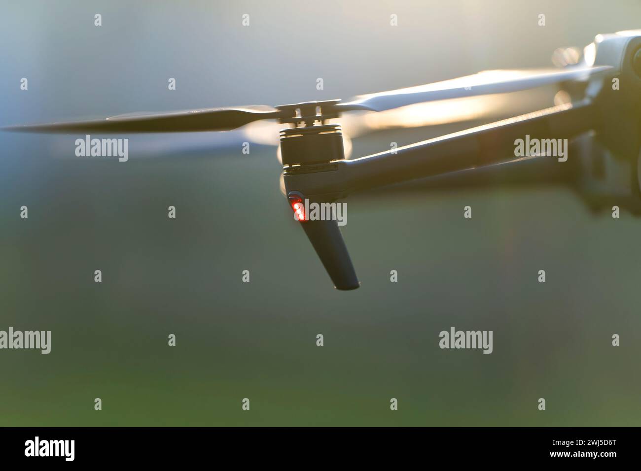 Drone aircraft with blurred fast rotating propellers and video camera ...