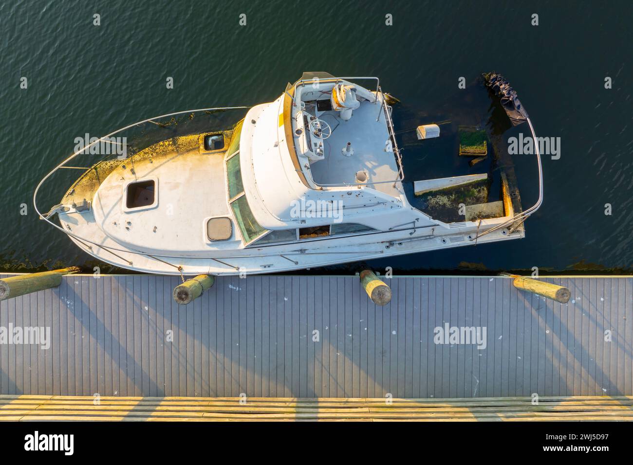 Half sunken sailing yacht capsized on shallow bay waters after ...