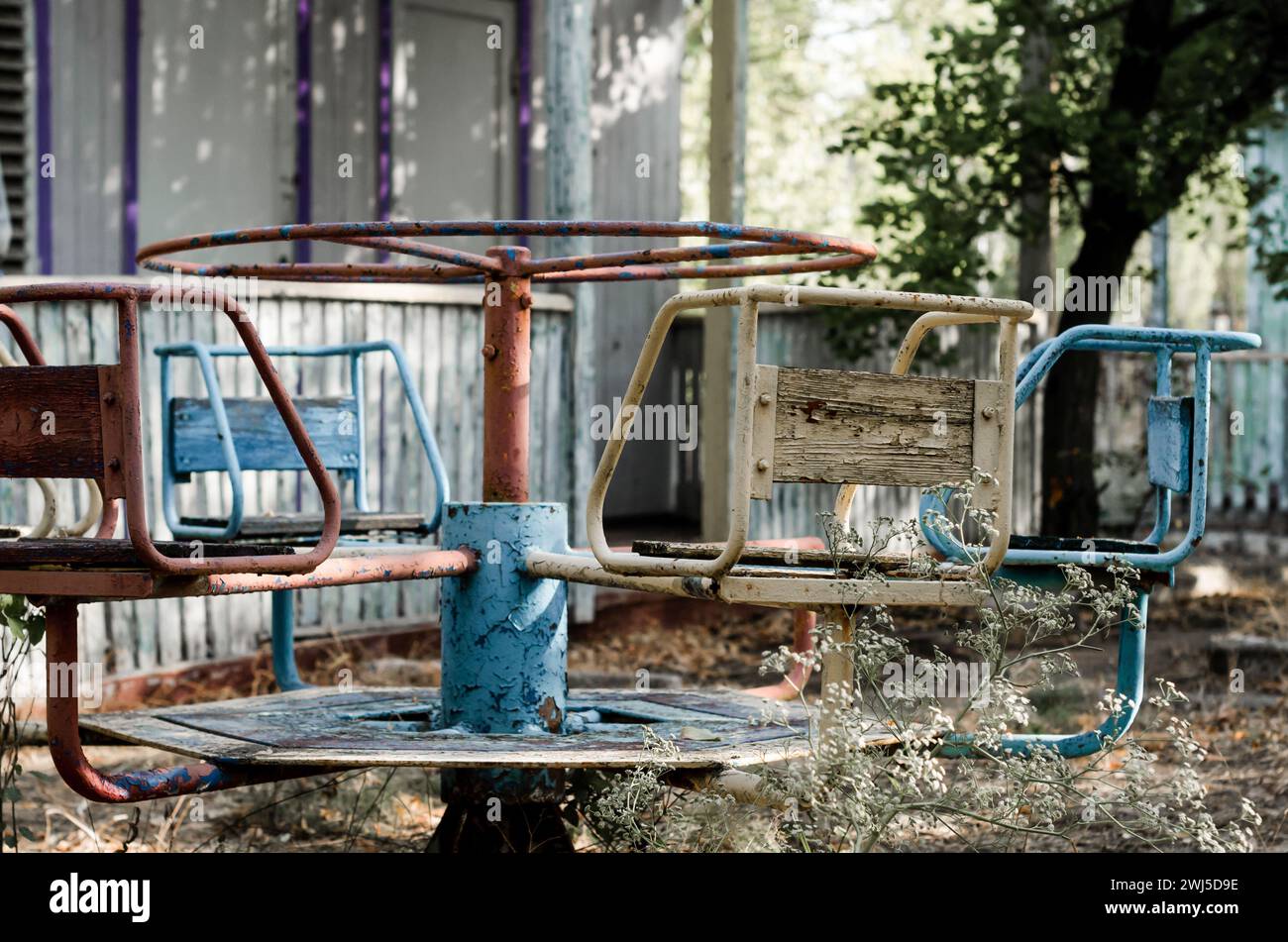 Old carousel on the background of an old house Stock Photo - Alamy