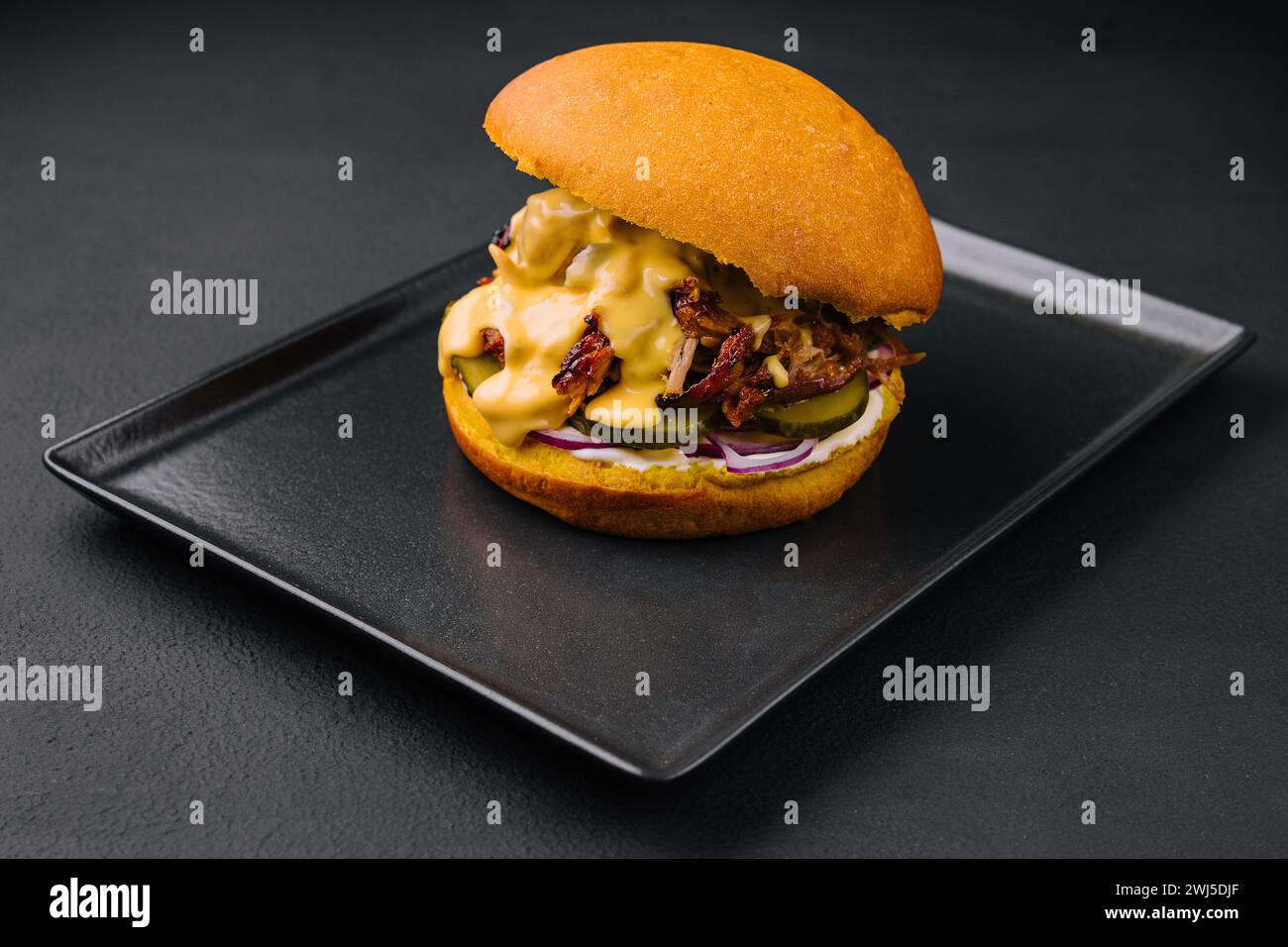 Delicious burger with torn meat on black tray Stock Photo - Alamy