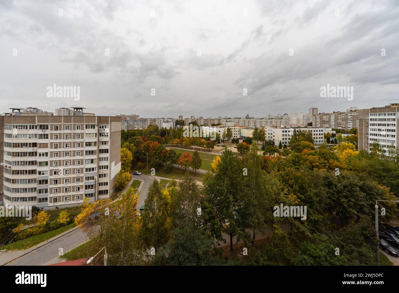 View of the city or yard from window of an apartment building in autumn ...