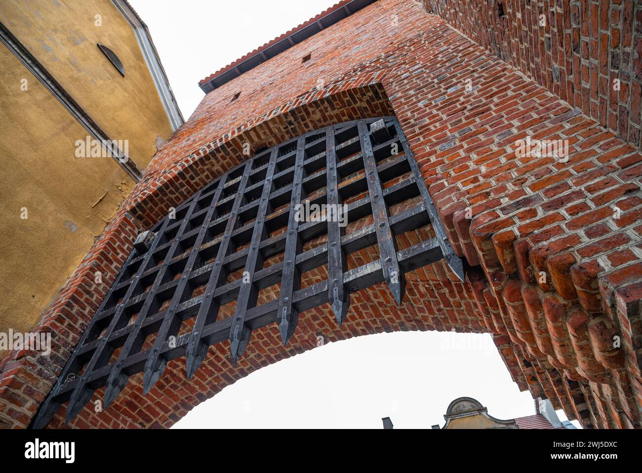 A low angle of an old brick arc with barred fence Stock Photo - Alamy