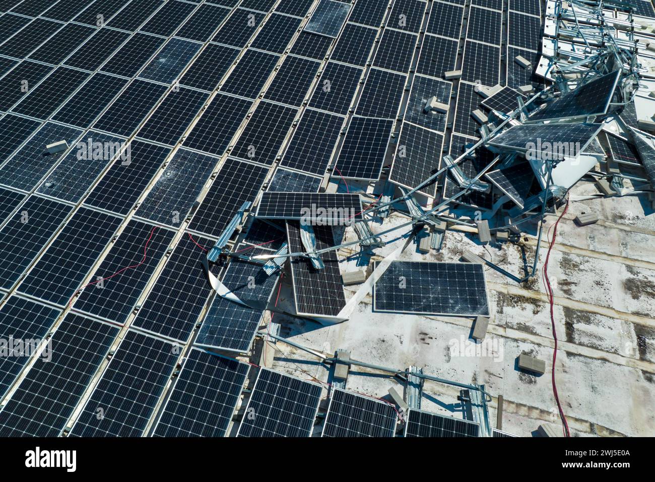 Aerial view of damaged by hurricane wind photovoltaic solar panels ...