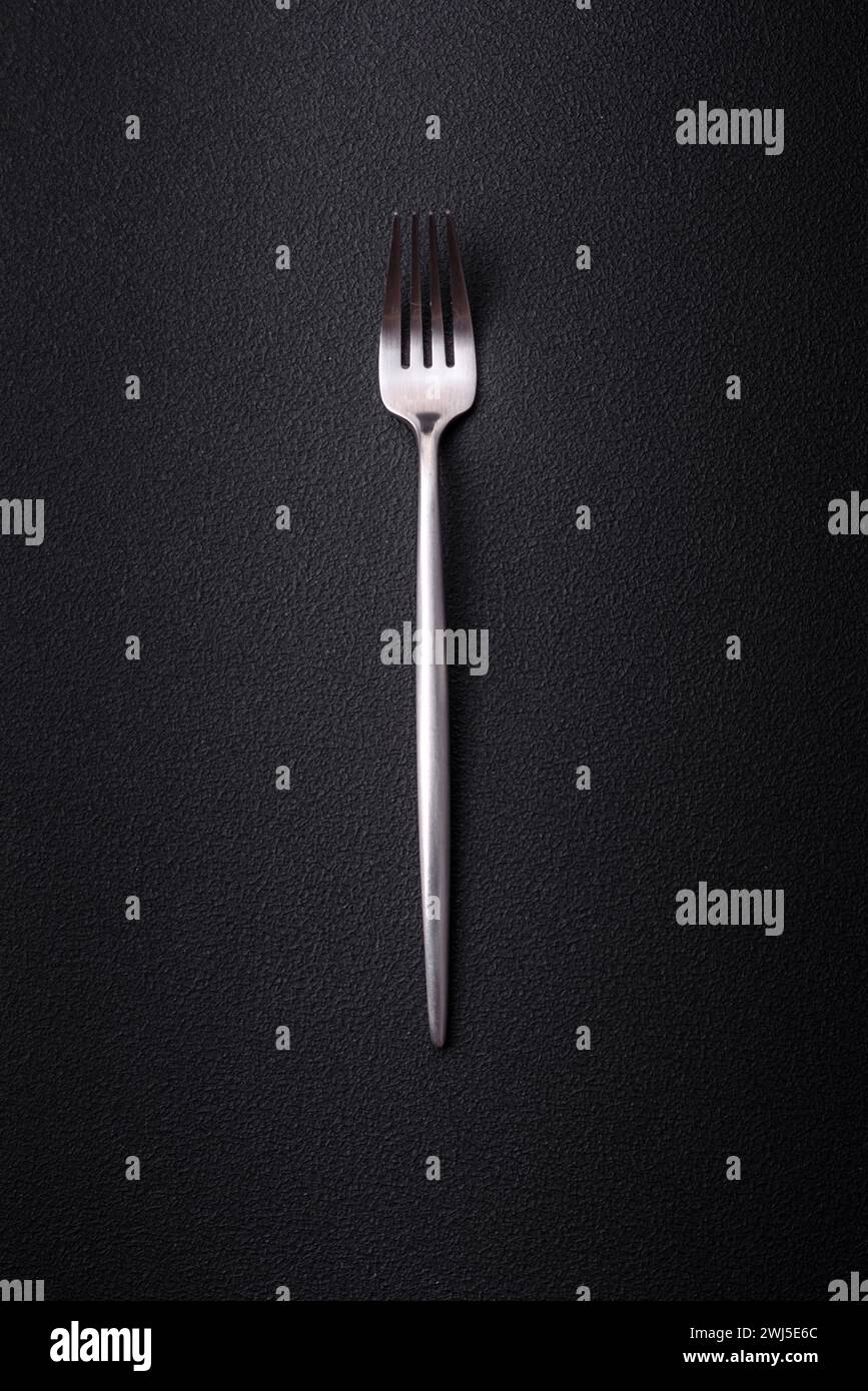 Metal kitchen fork on a dark textured concrete background Stock Photo ...