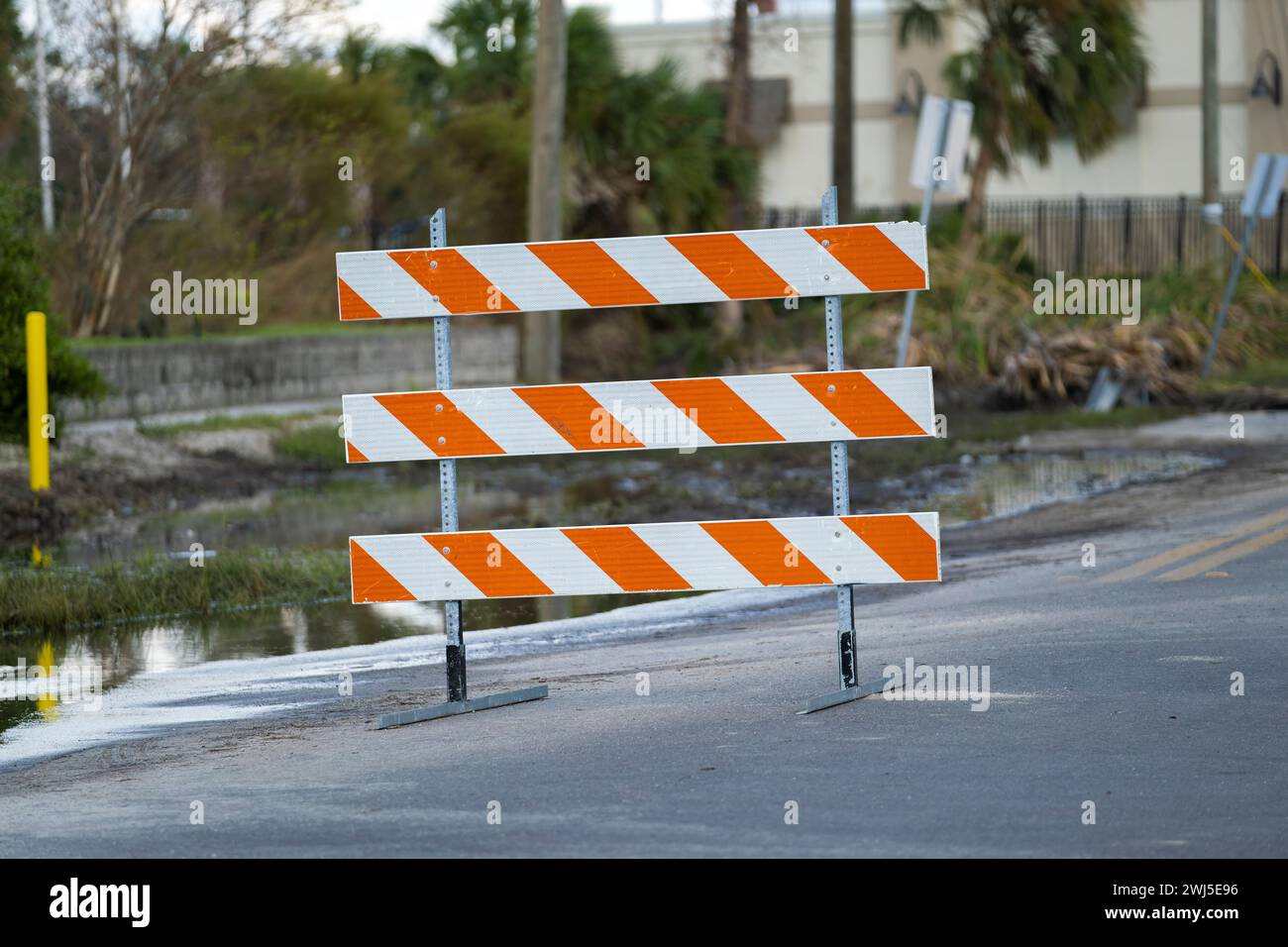 Yellow protective barrier at street construction site. Warning road ...