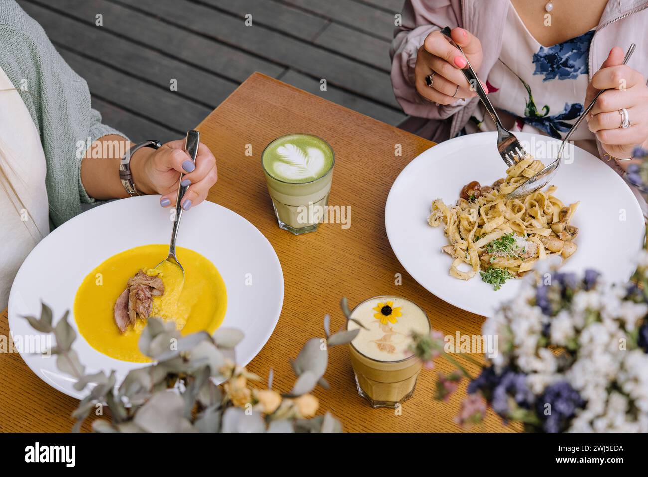 Two girls have lunch in a restaurant Stock Photo - Alamy