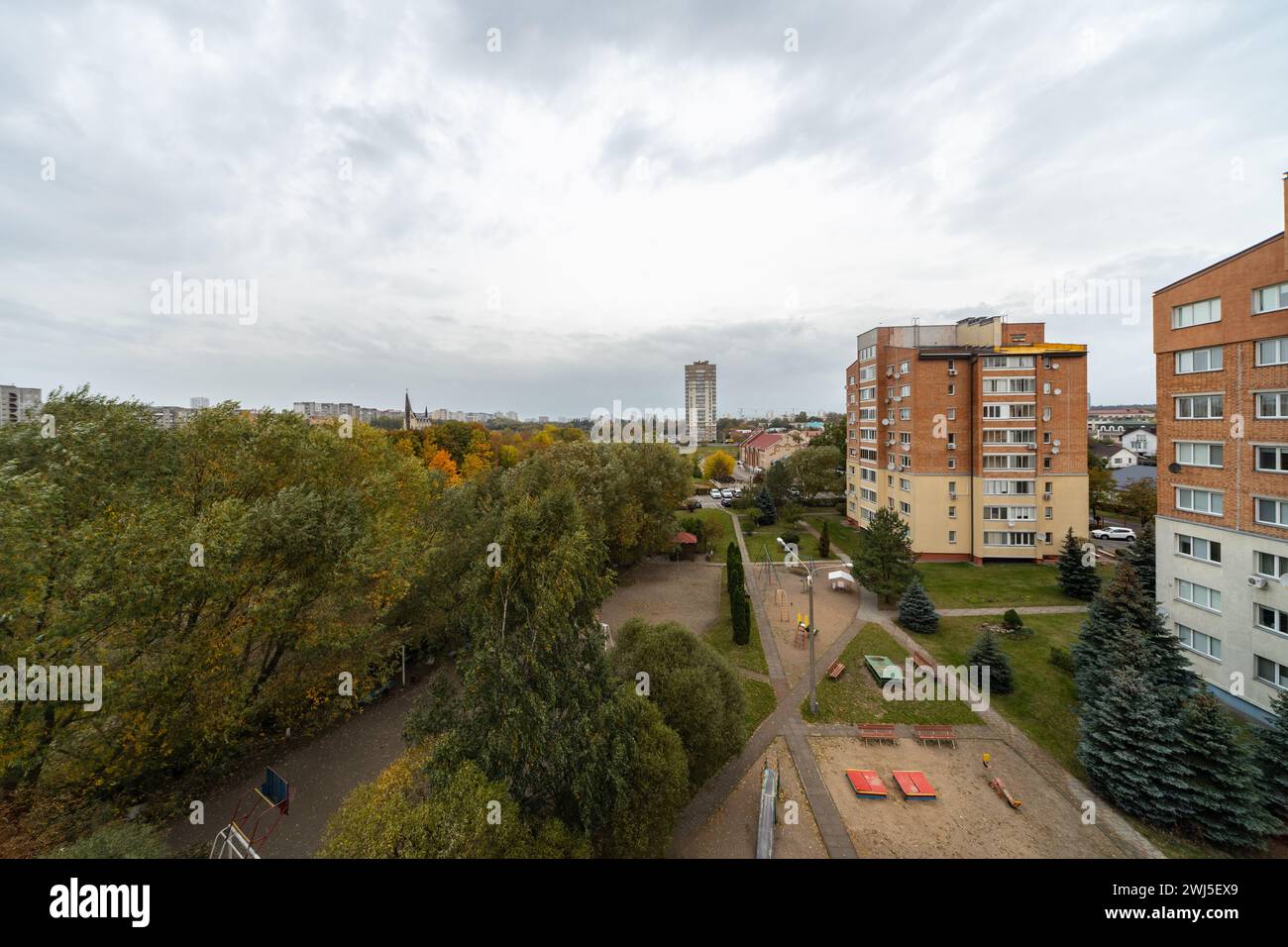 View of the city or yard from window of an apartment building in autumn ...