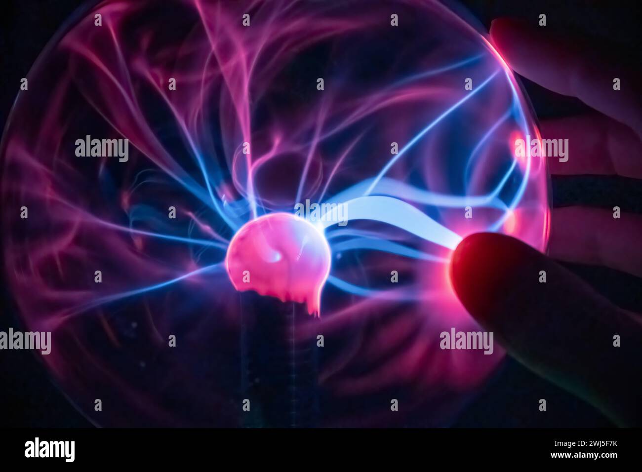 Scientist hand is touching a plasma ball Stock Photo - Alamy