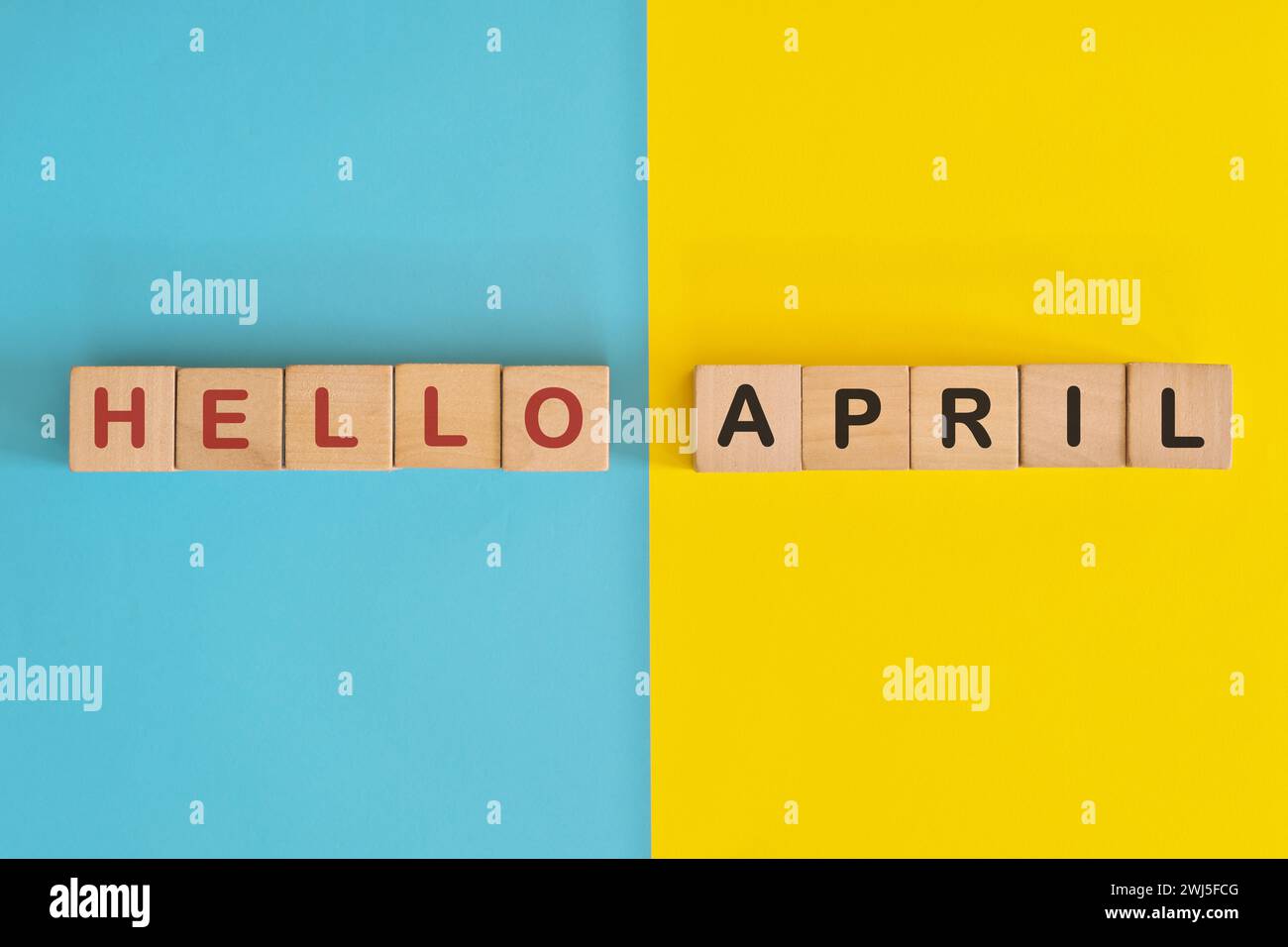 Hello month of April concept. Wooden blocks typography in bright blue ...