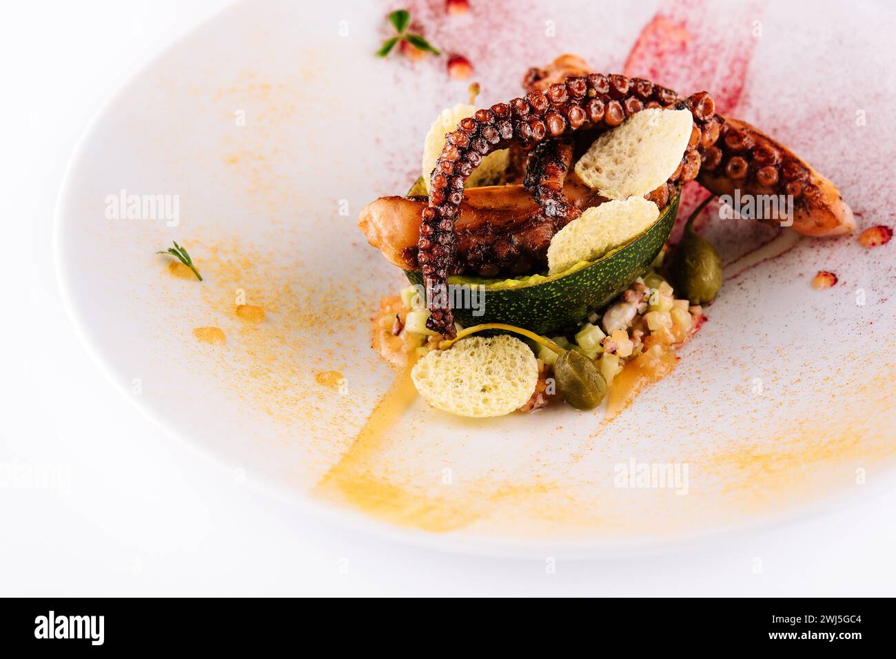 Fried octopus with avocado on plate Stock Photo - Alamy