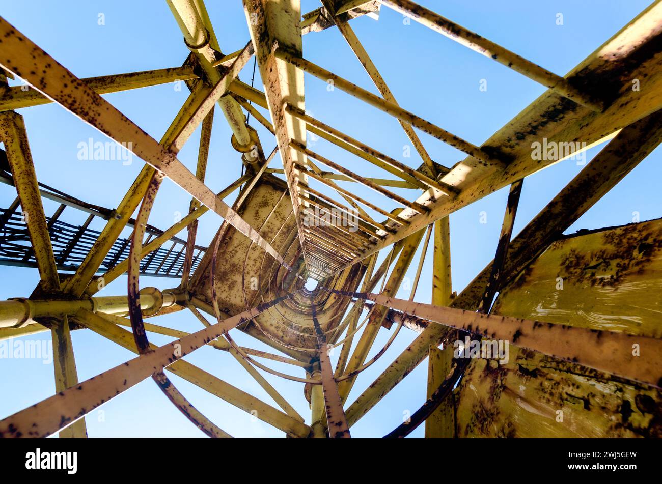 Old high metal tower building with stairs bottom view Stock Photo - Alamy