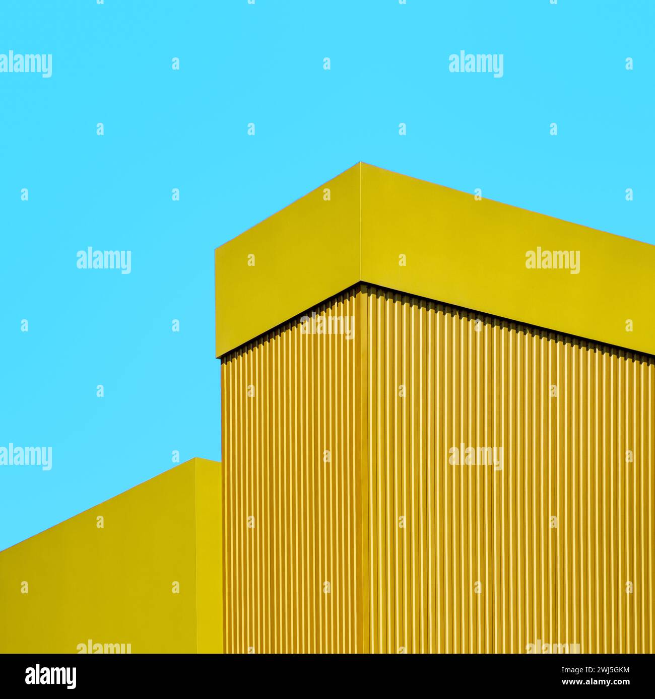 Orange wall of a modern building against a blue sky Stock Photo - Alamy