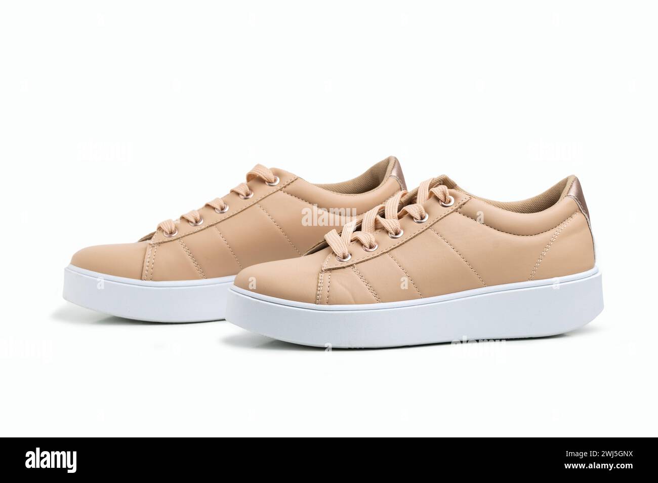 Pair of female sport shoes on white background Stock Photo - Alamy