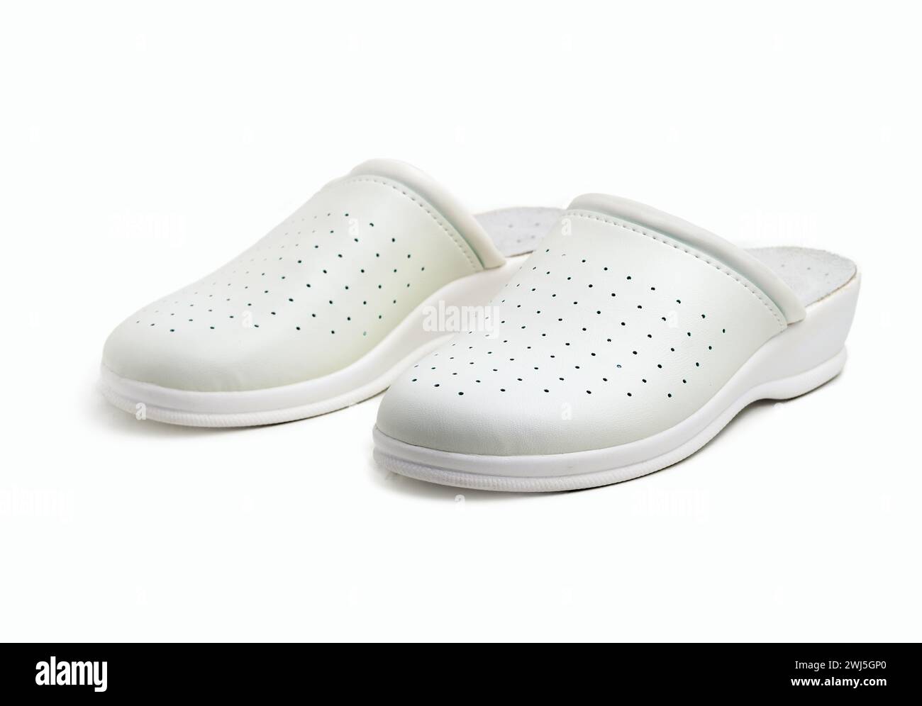 A pair of white professional ventilated work clogs isolated over white ...