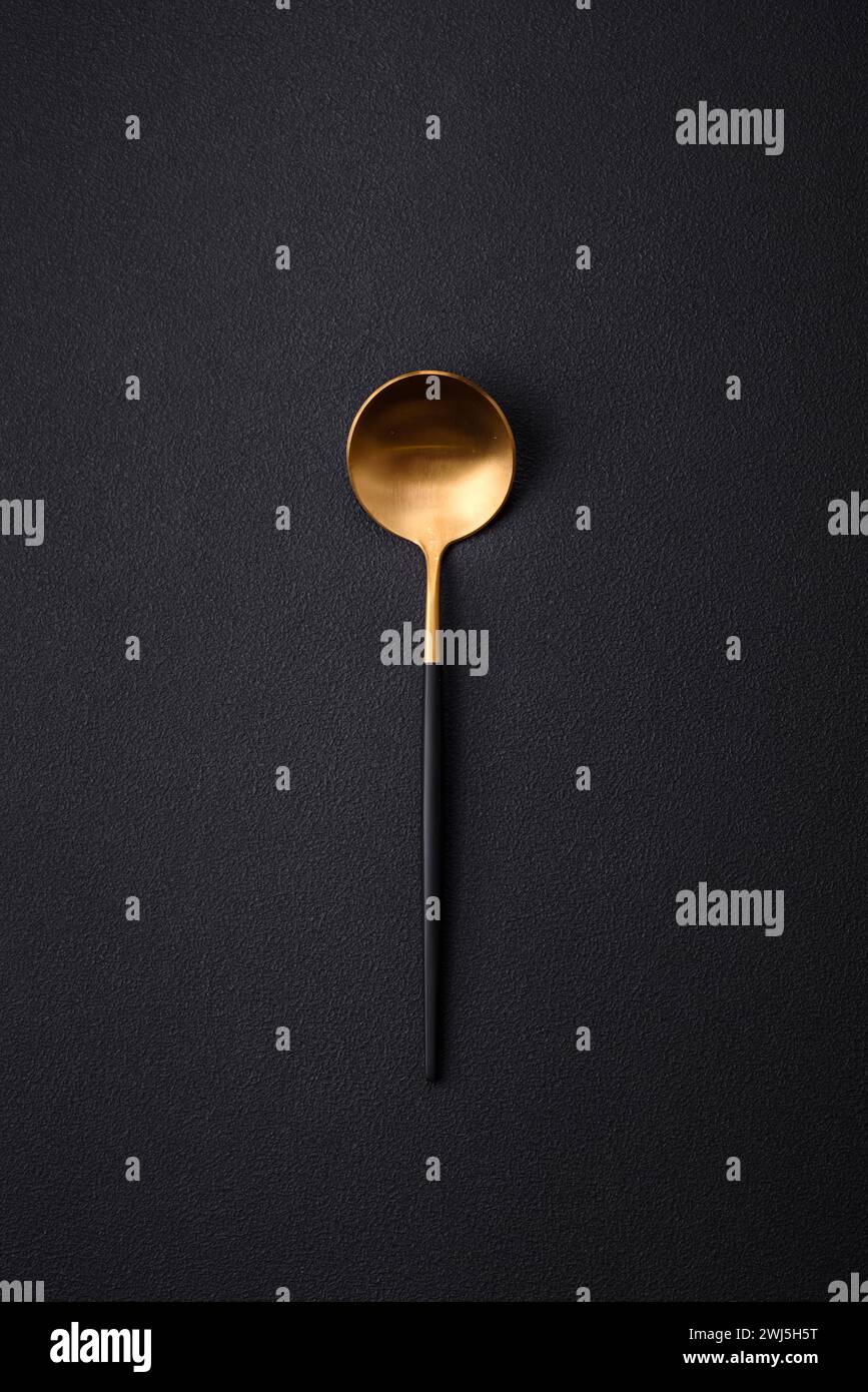 Empty metal spoon on dark textured concrete background. Cutlery Stock ...