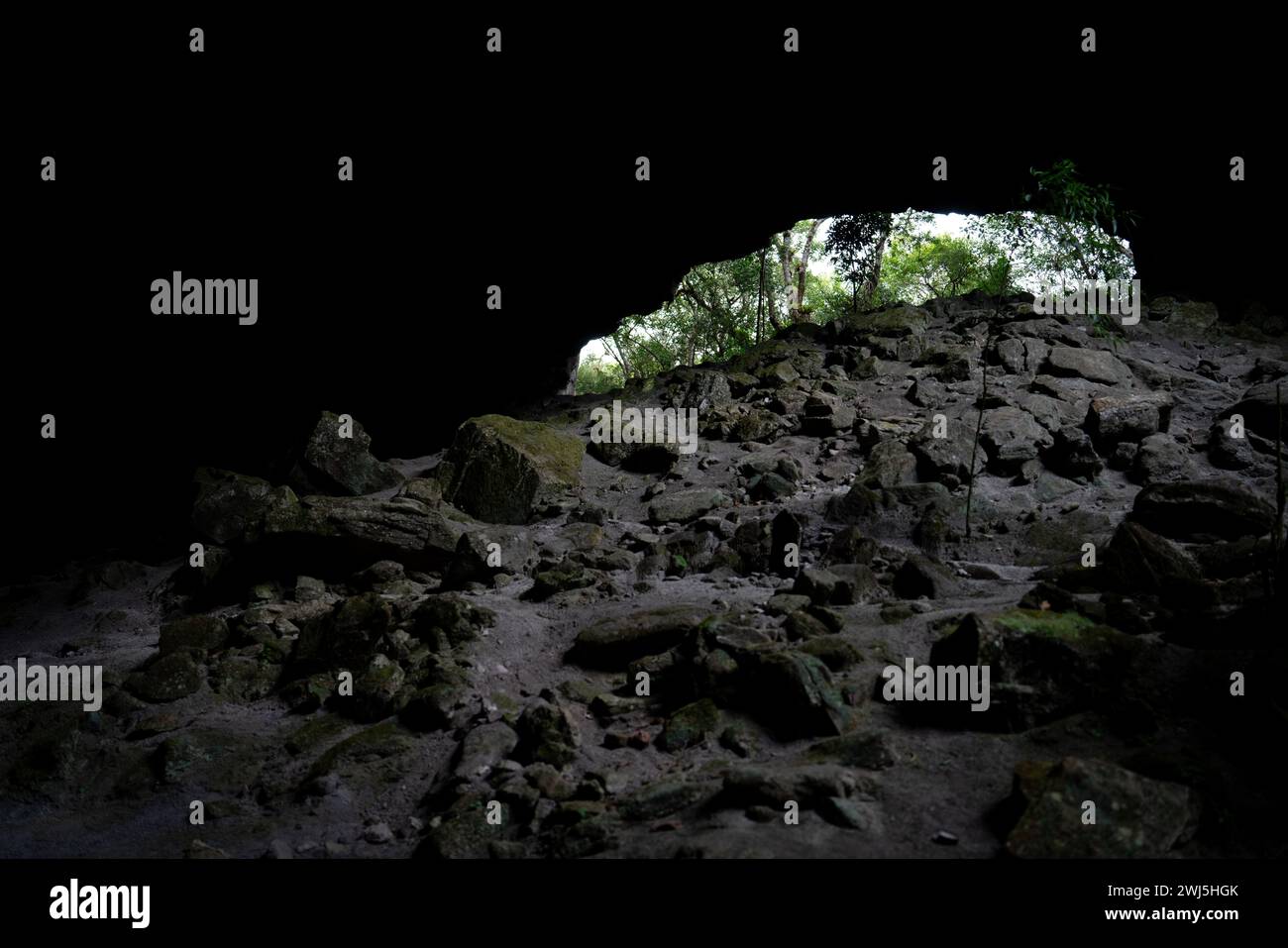 Light Breaking Through the Darkness in a Rocky Cave Entrance Stock ...