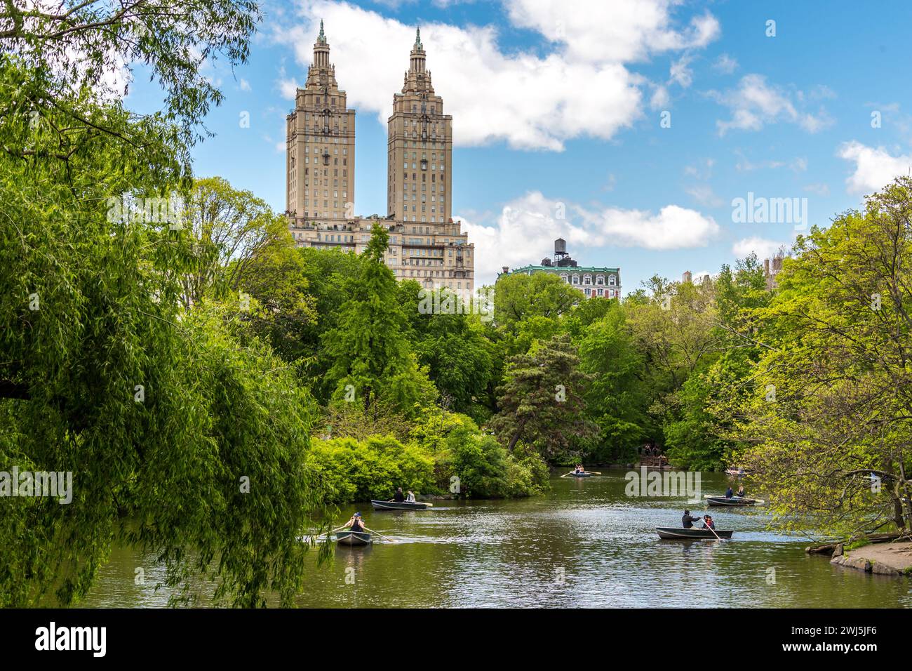 Row boats in lake in Central Park with Eldorado building in distance ...