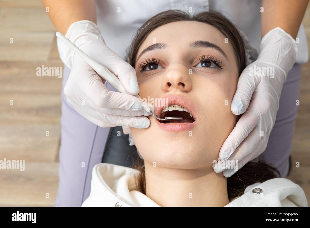 Dentist examining patient teeth with dental mirror Stock Photo - Alamy