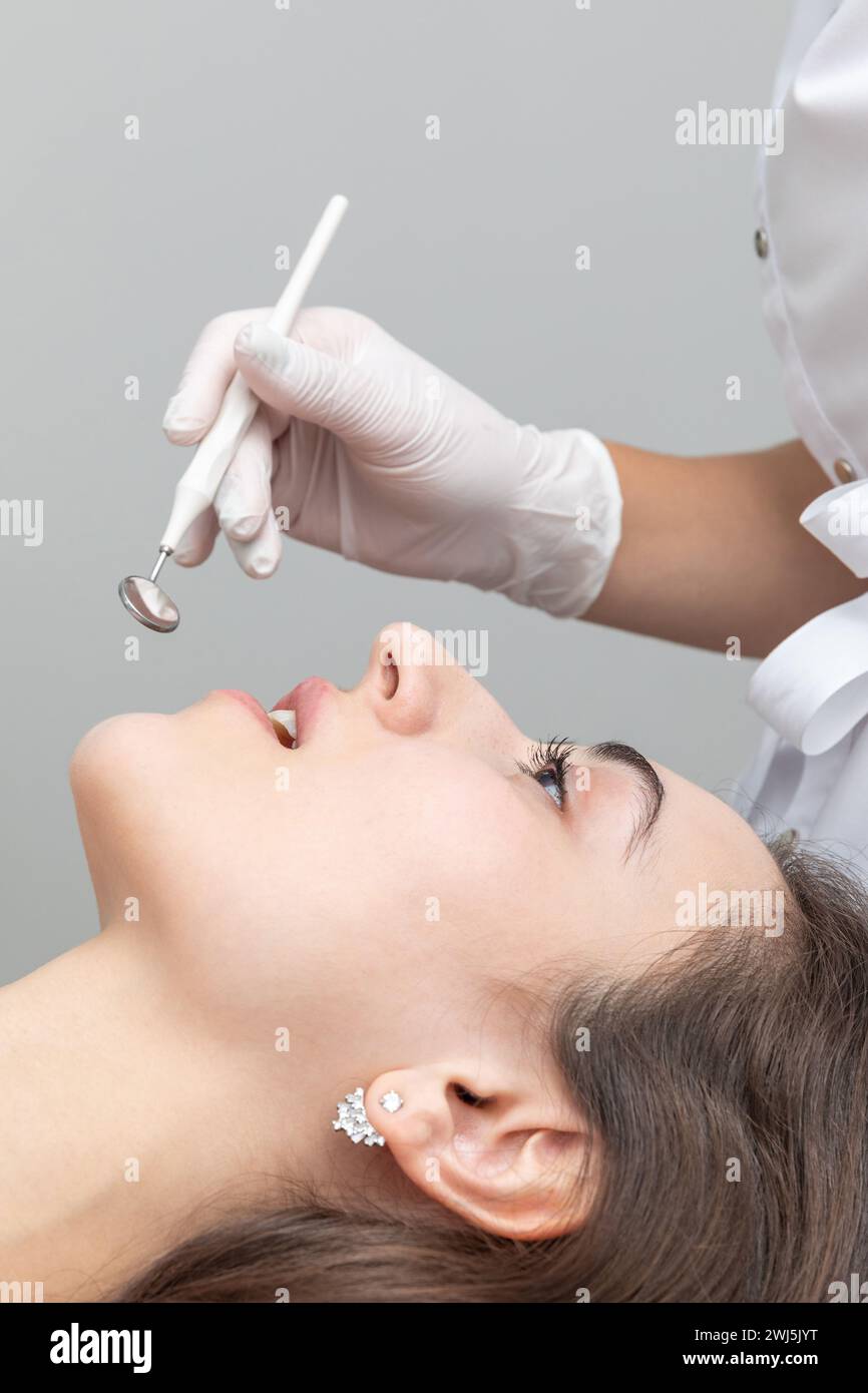 Dental check up in dential clinic. Dentist examining patient teeth with ...