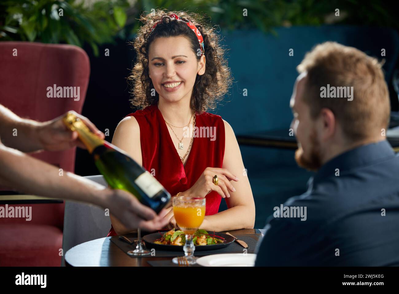 Waiter serving couple champagne hi-res stock photography and images - Alamy
