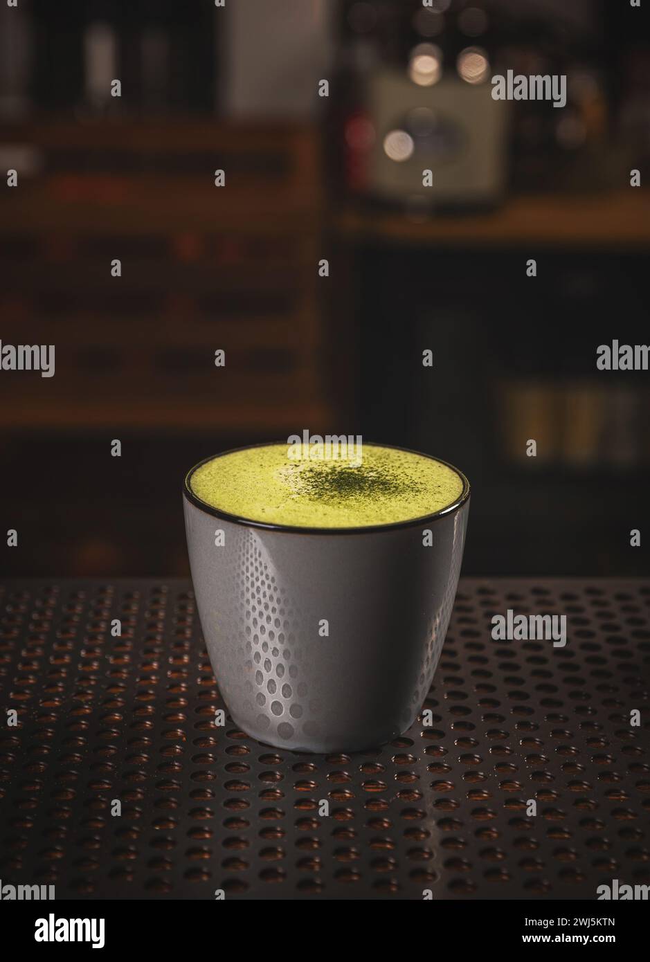 Matcha green tea latte in a cup on bar counter Stock Photo - Alamy