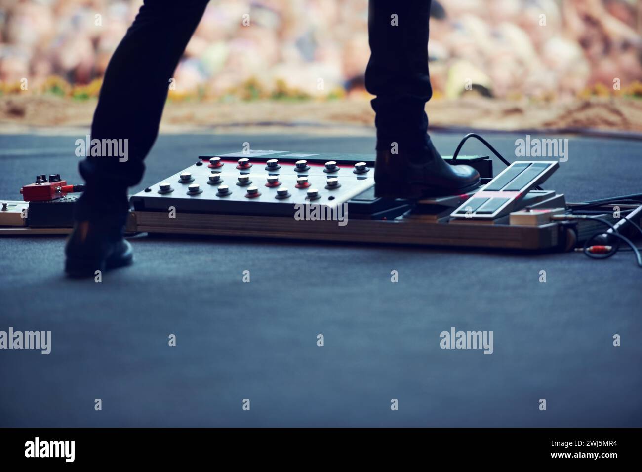 Artist, stage and feet on equipment of instrument at concert, music ...