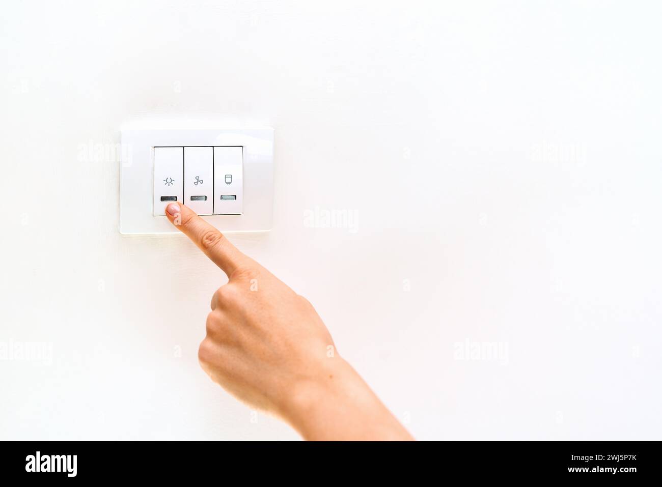Female finger on light switch close-up Stock Photo - Alamy