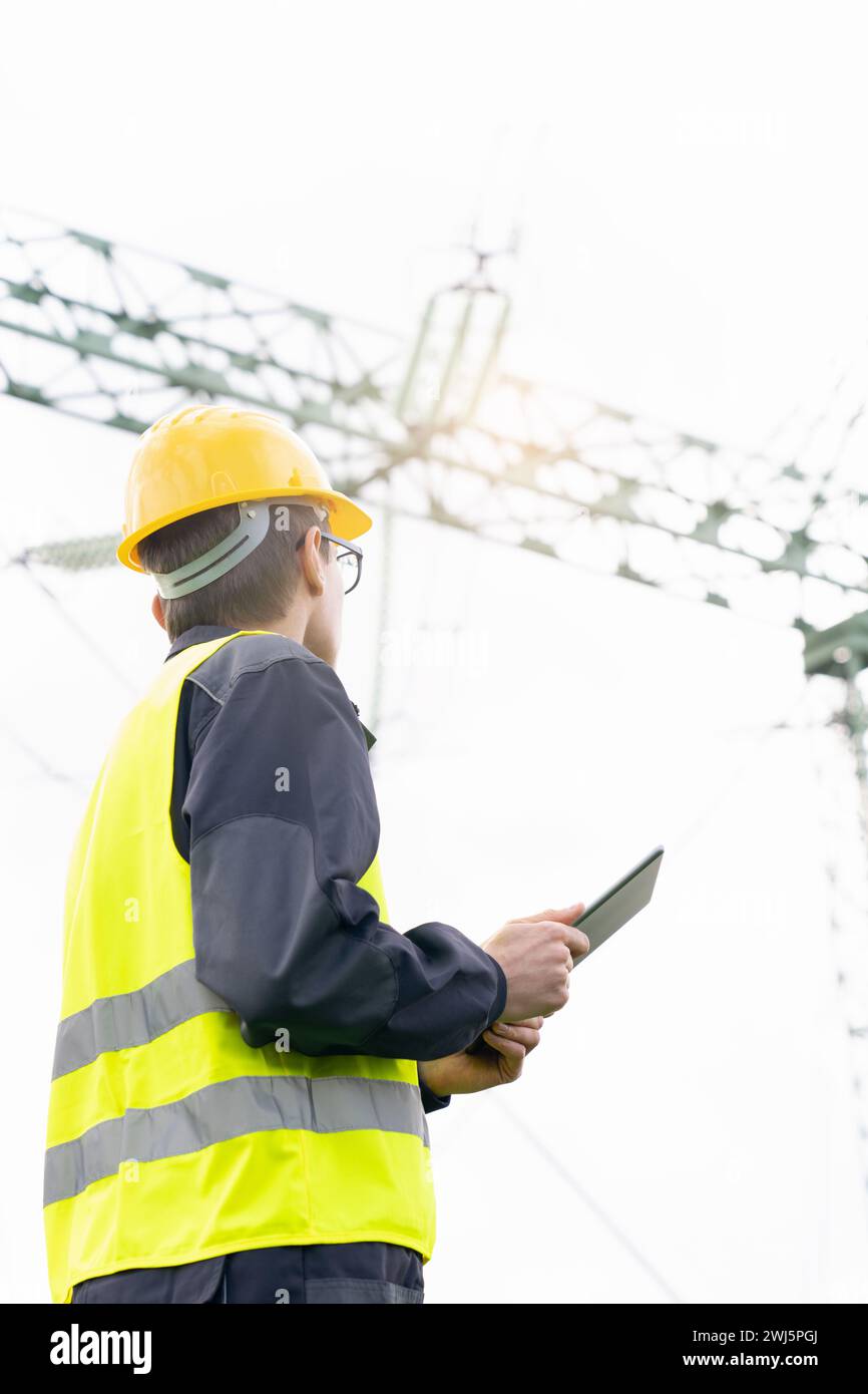 Engineer with digital tablet on a background of power line tower Stock ...