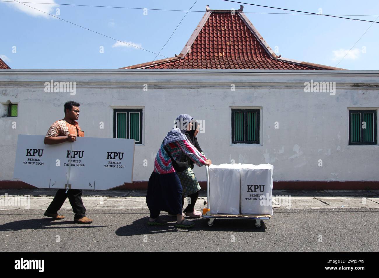 People use a cart to transport ballot boxes ahead of the Feb. 14 ...