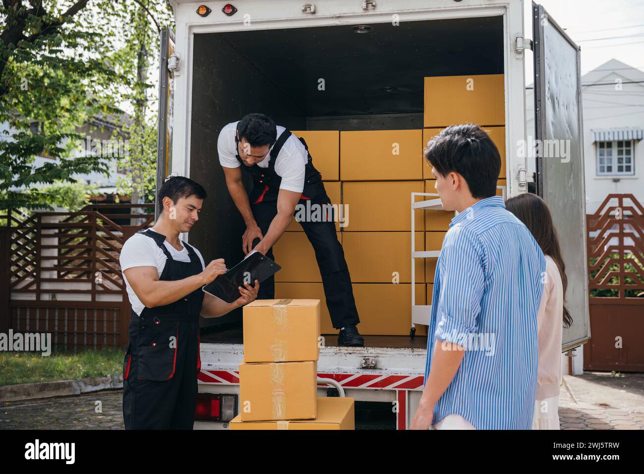 A couple signs delivery checklist after furniture upload delighted by ...