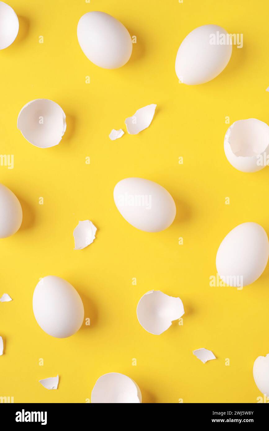 White Easter eggs and shells on a bright yellow background Stock Photo ...