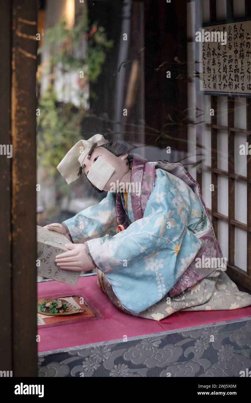 Detail of puppet serving food, wearing a facemask, in street in ...