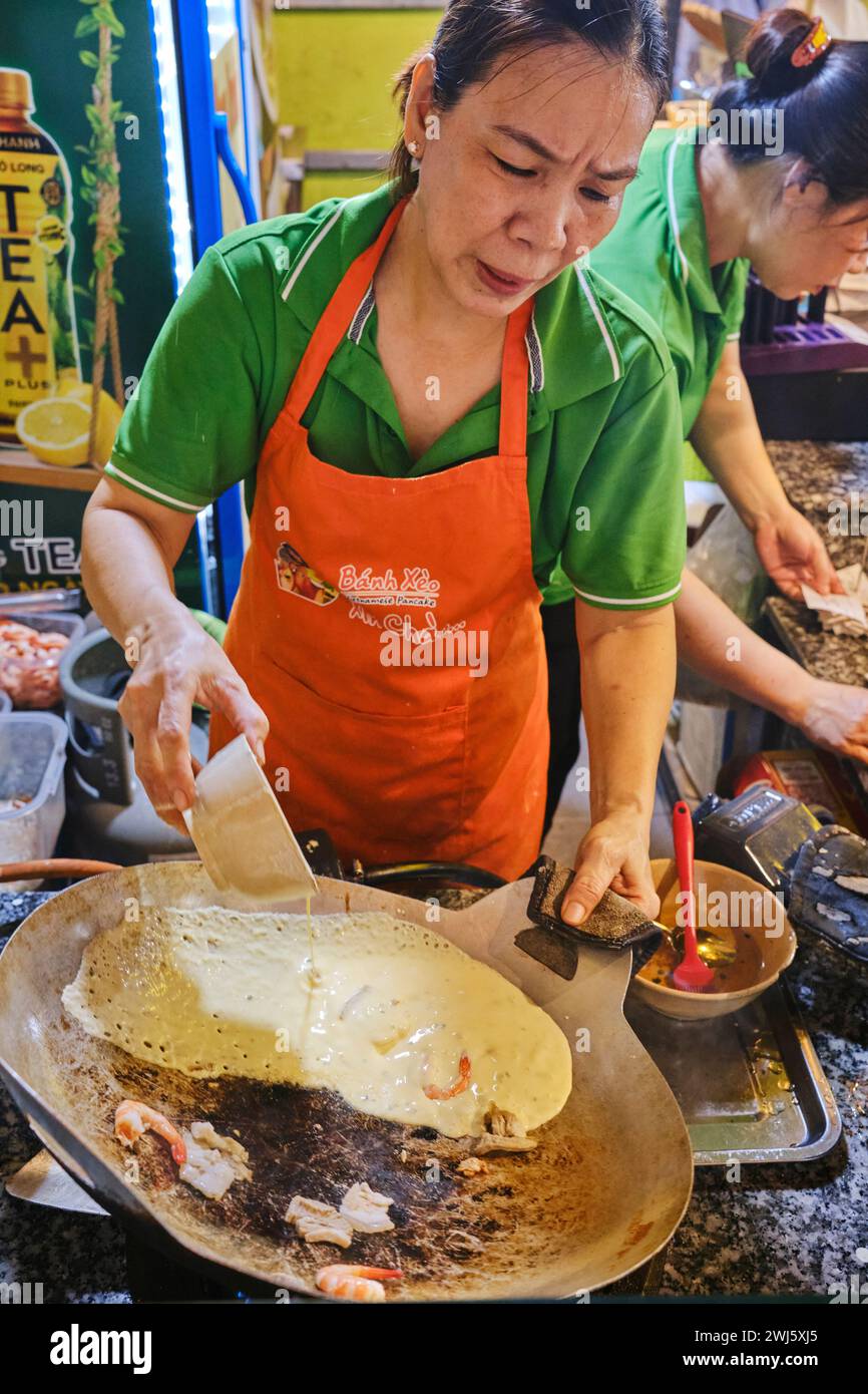 Jan 2024, A person cooking Banh Xeo Vietnamese pancake at Ben Nghe ...