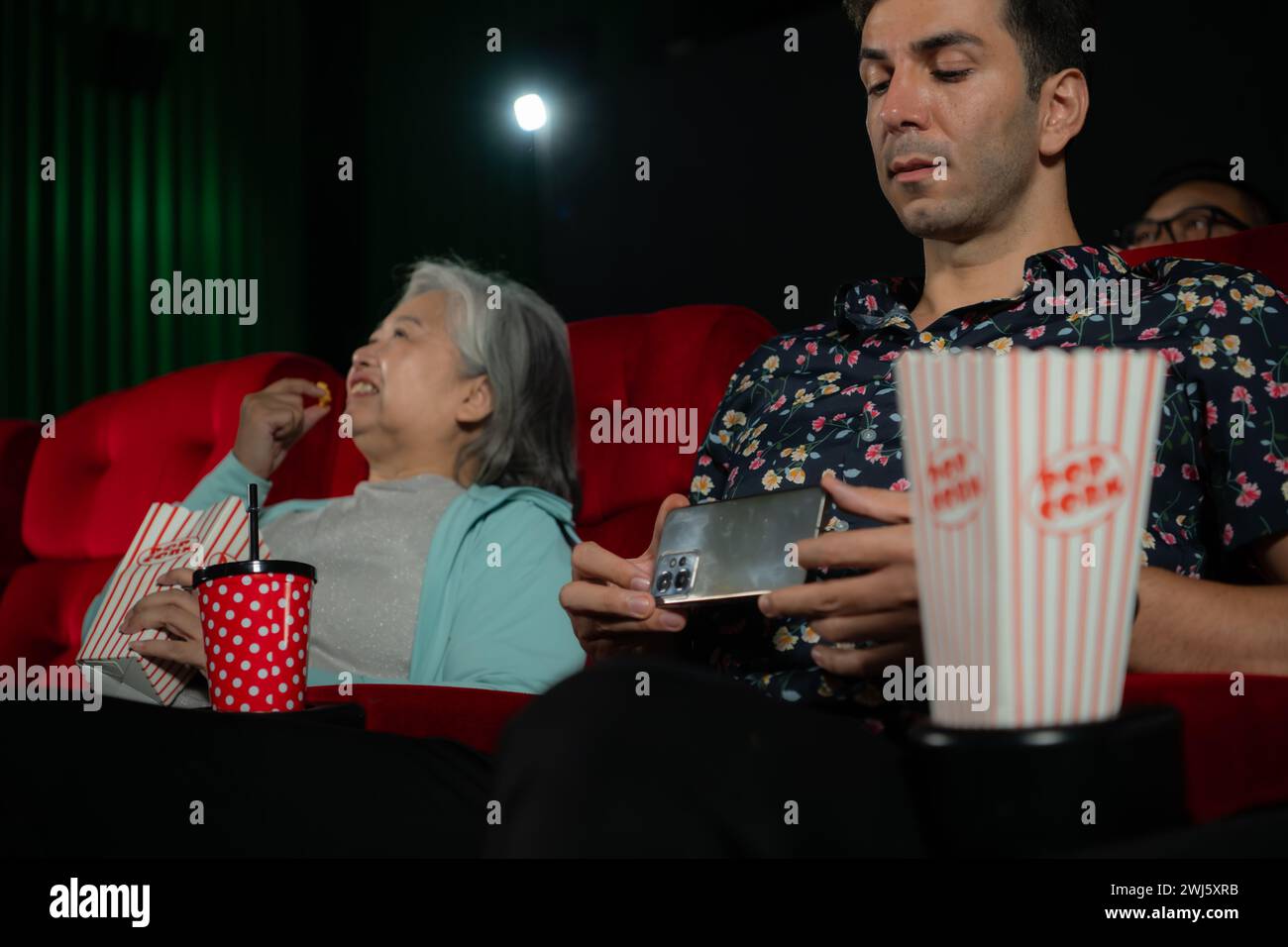 A young man was secretly recording a movie in a movie theater while ...