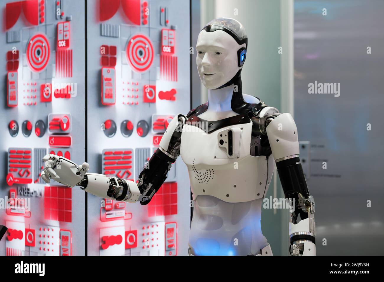 Humanlike robot with high-tech design standing against digital backdrop ...