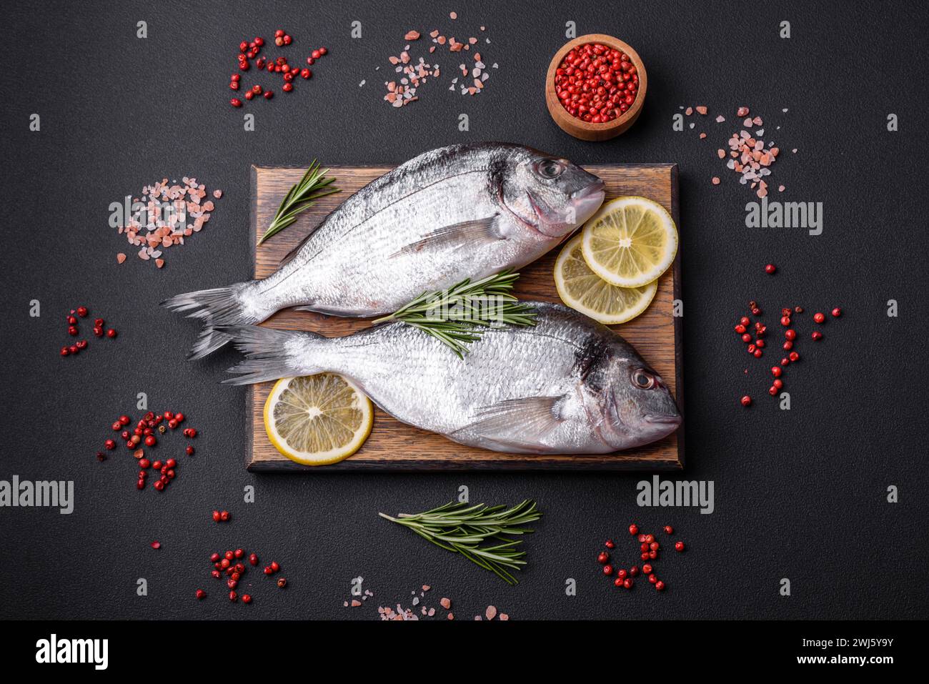 Fresh raw dorado fish with spices, herbs, salt and lemon Stock Photo ...
