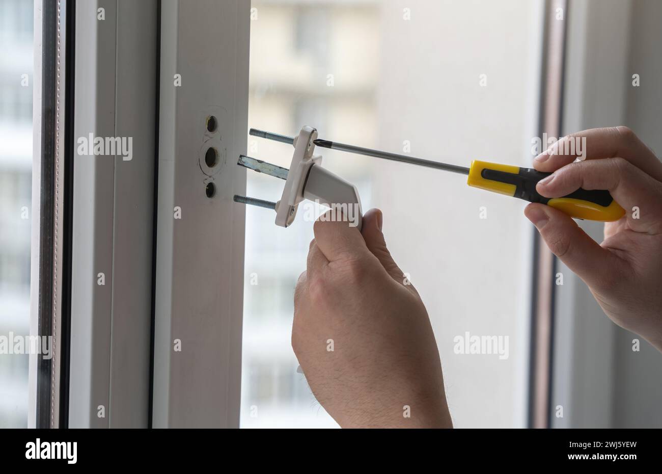 Removing or installing the handle on the window. Protection against ...