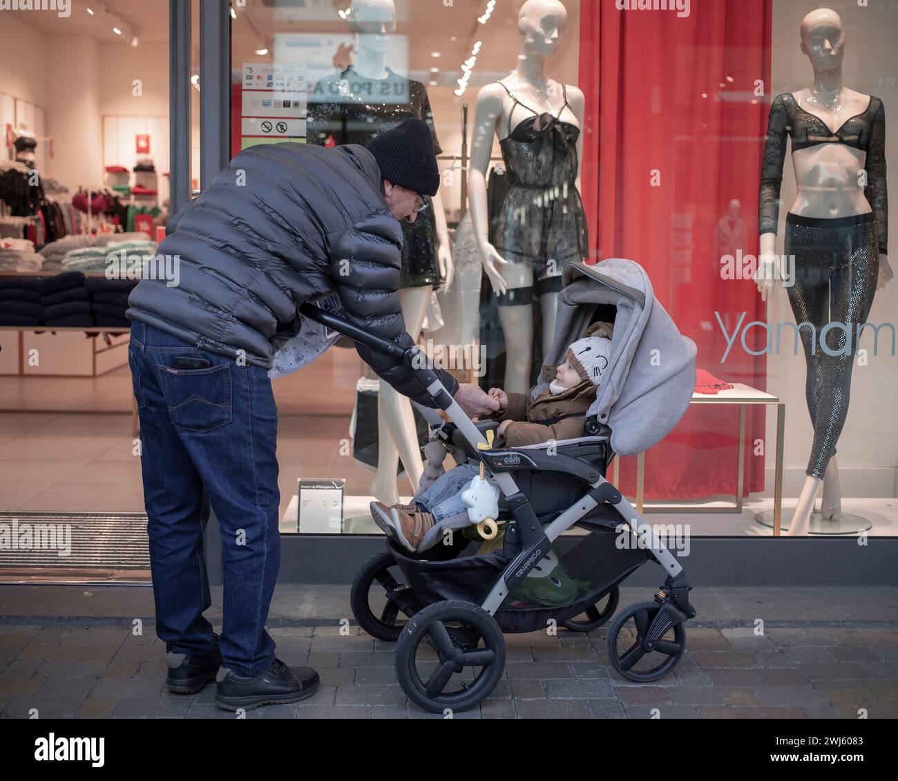 Italy, Jan 16, 2024: Grandfather and grandson walking along “Vicolungo ...