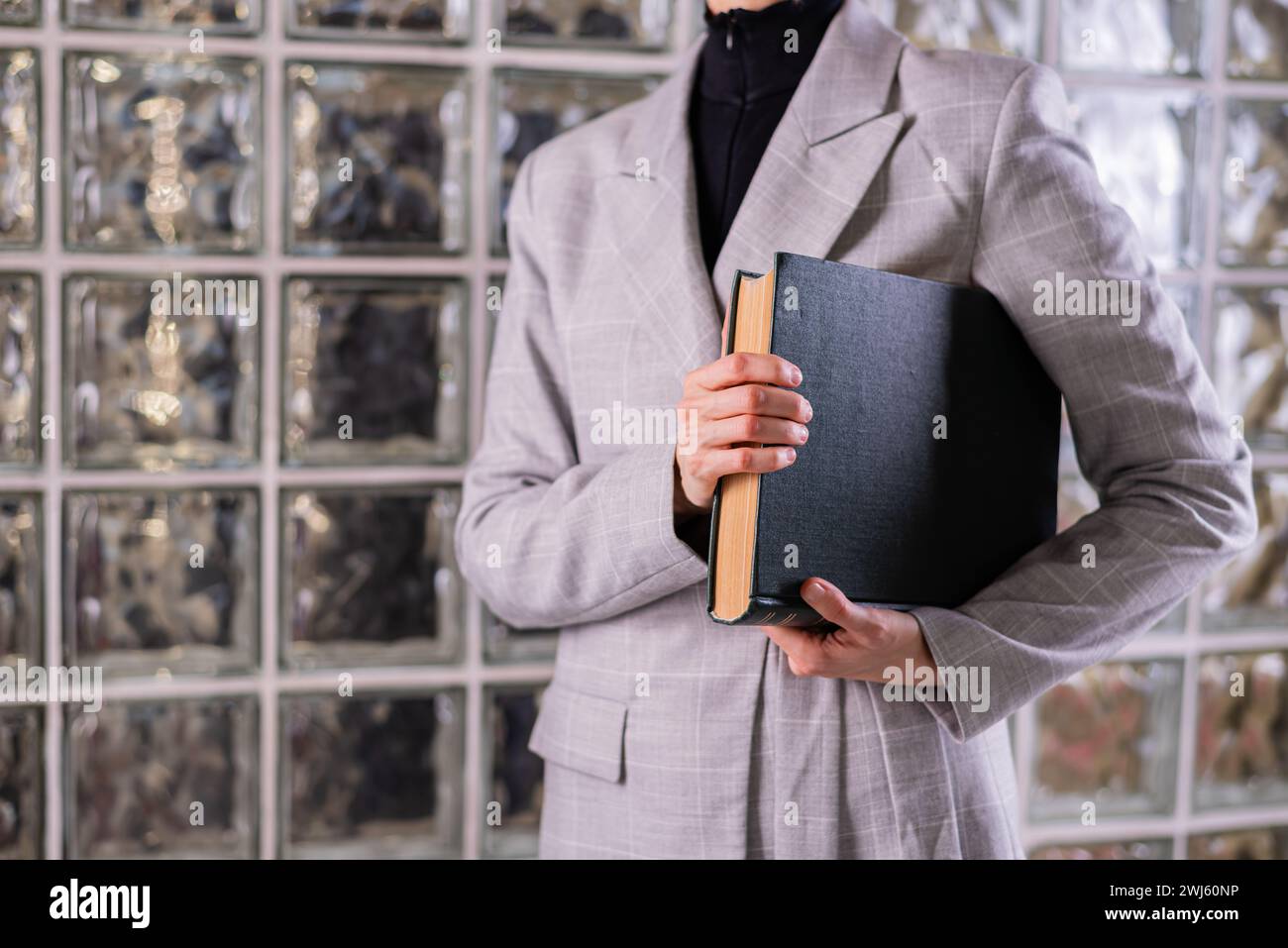 a girl with a big black book under her arm. business office style Stock ...