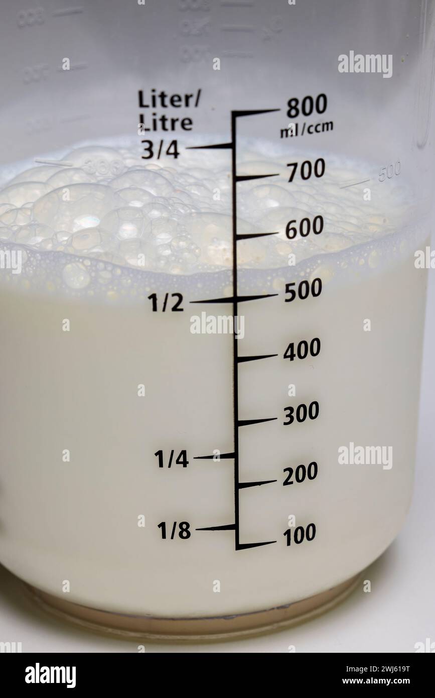 a container with graduated milk for measurement Stock Photo - Alamy