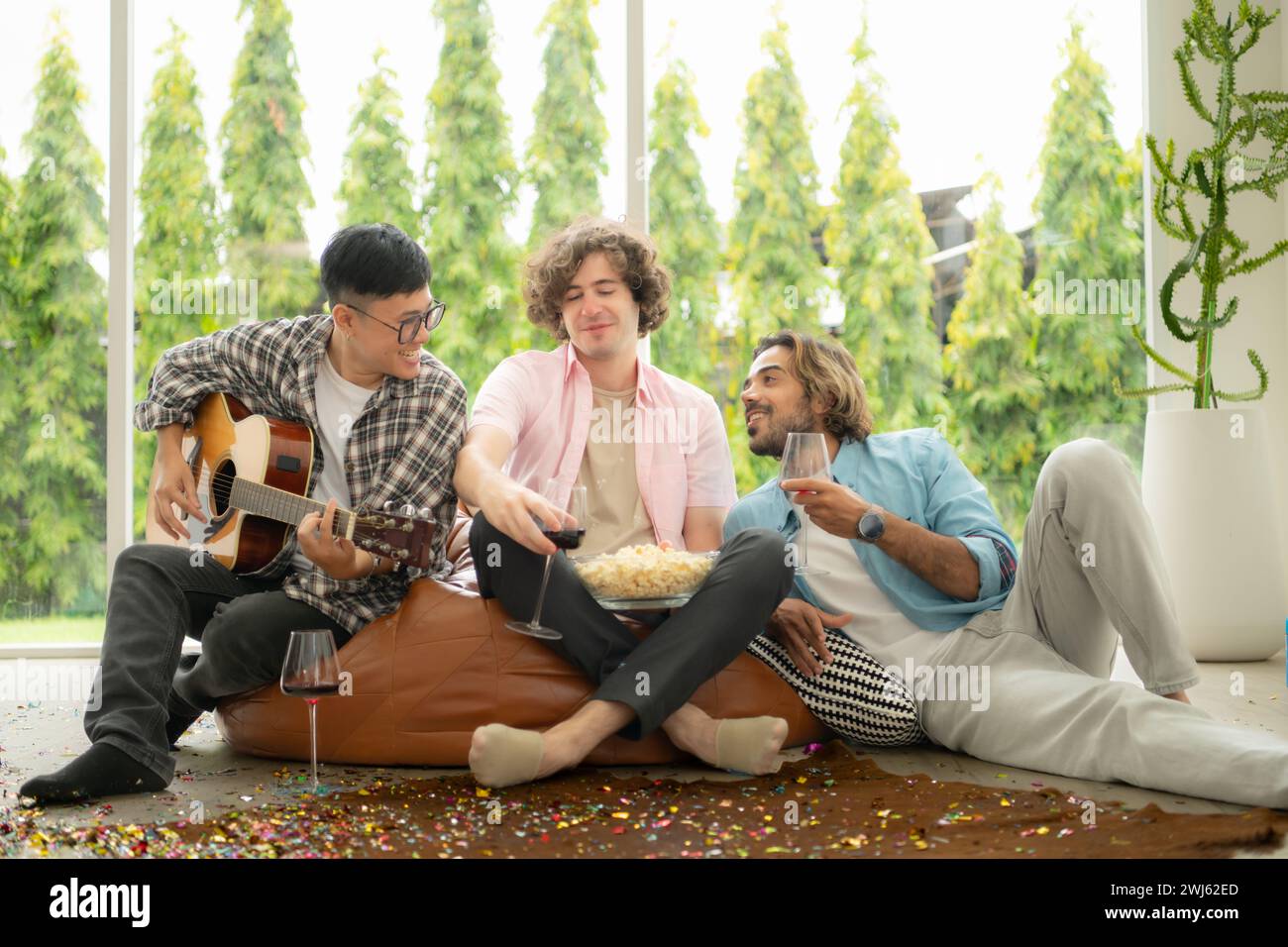 Multiethnic group of friends having fun playing guitar and singing ...