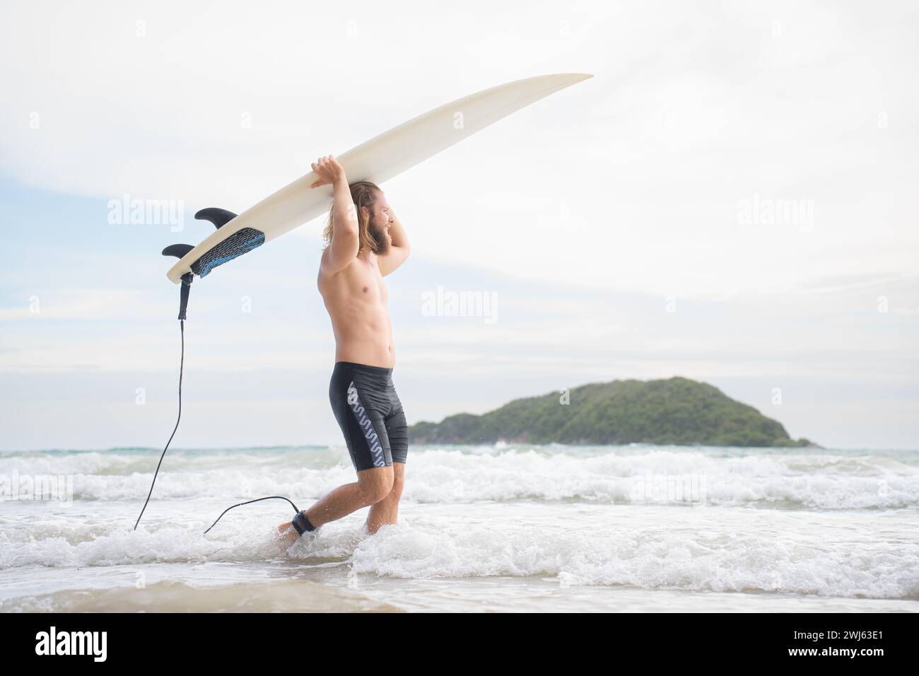 Surfer man with his surfboard on the beach Stock Photo - Alamy