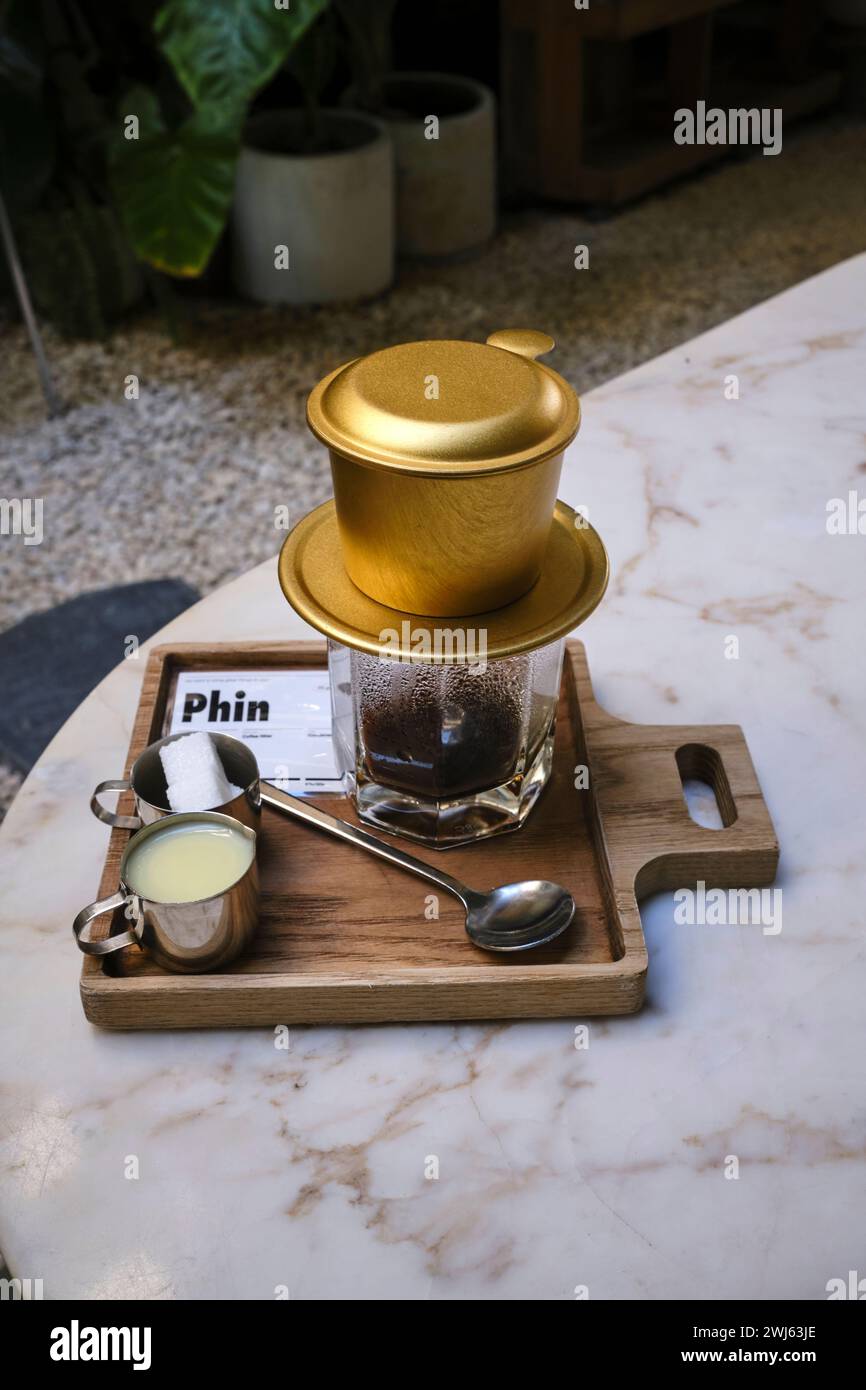 Vietnamese drip filter coffee served with condensed milk and sugar on ...