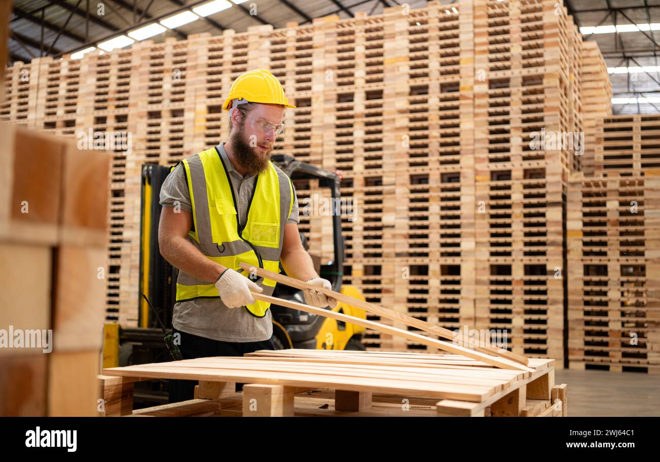 Portrait of young male carpenter working in a woodworking factory, He ...