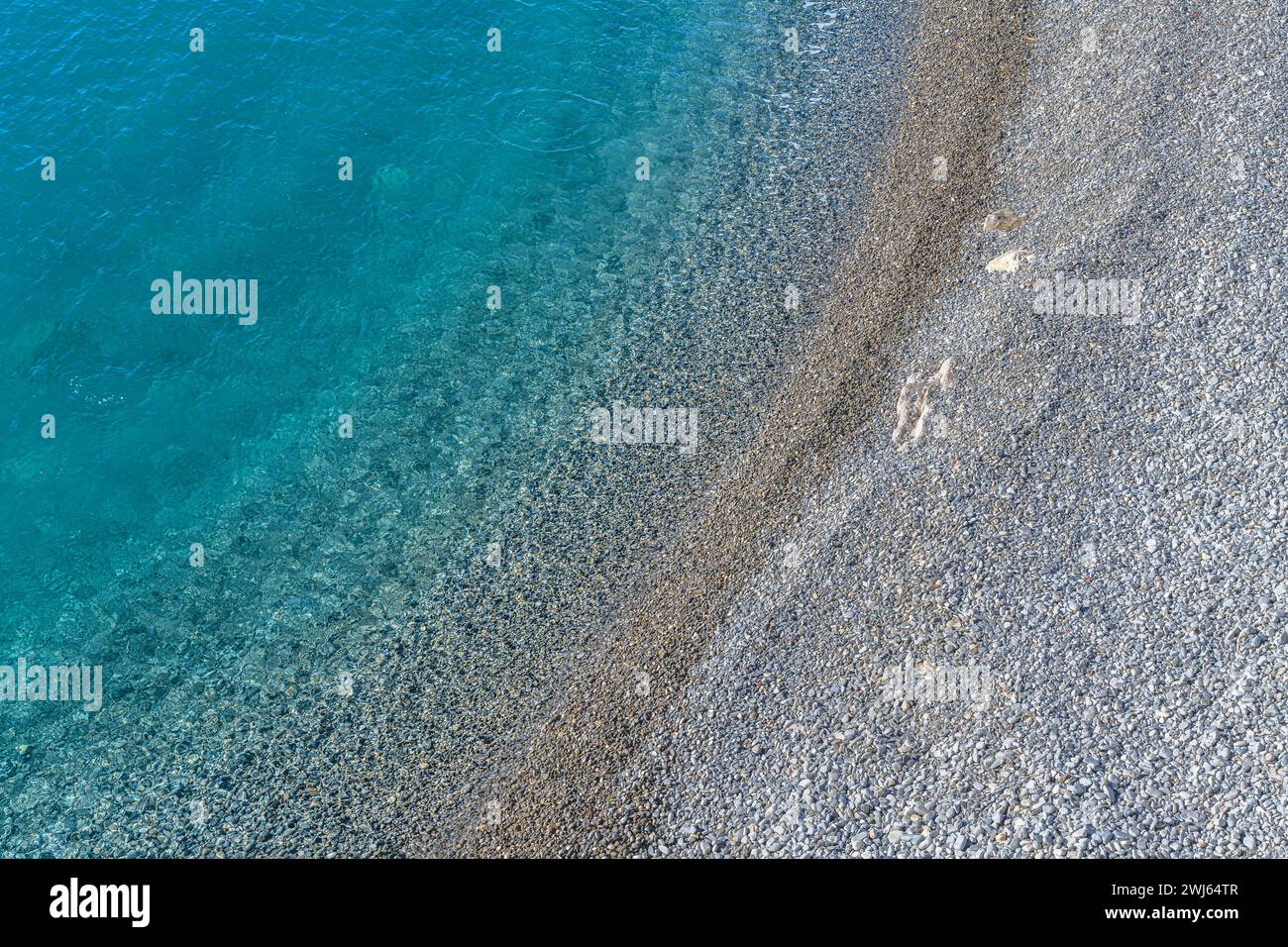 The pebble beach and clear waters of Castel Plage in Nice, on the ...