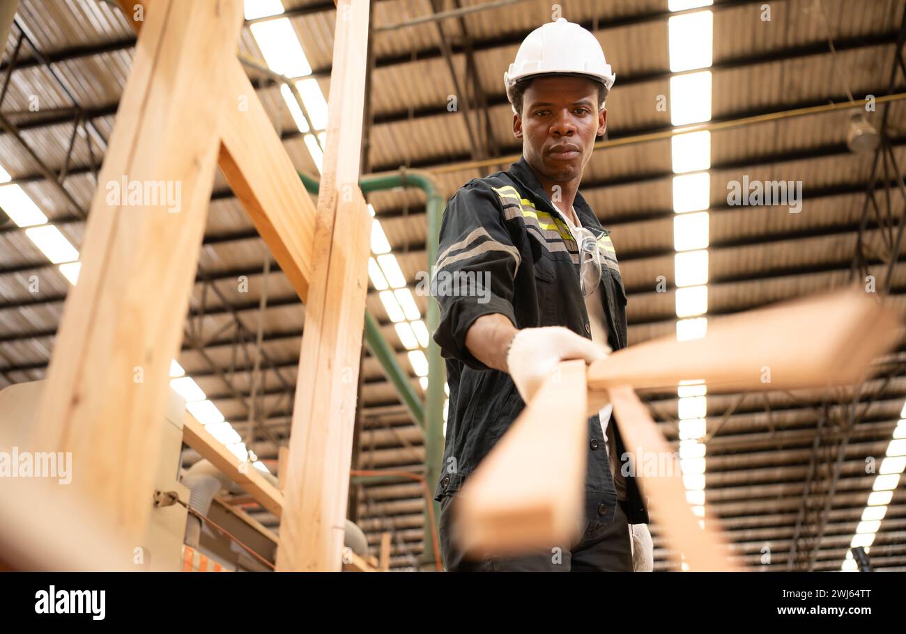 A carpenter works in a wooden factory, Gather wood that has passed ...