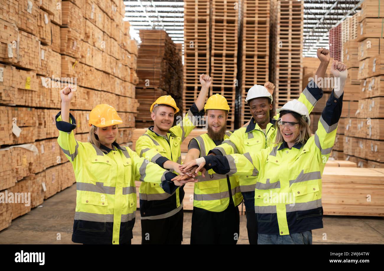 Portrait of happy workers giving high five at warehouse. This is a a ...