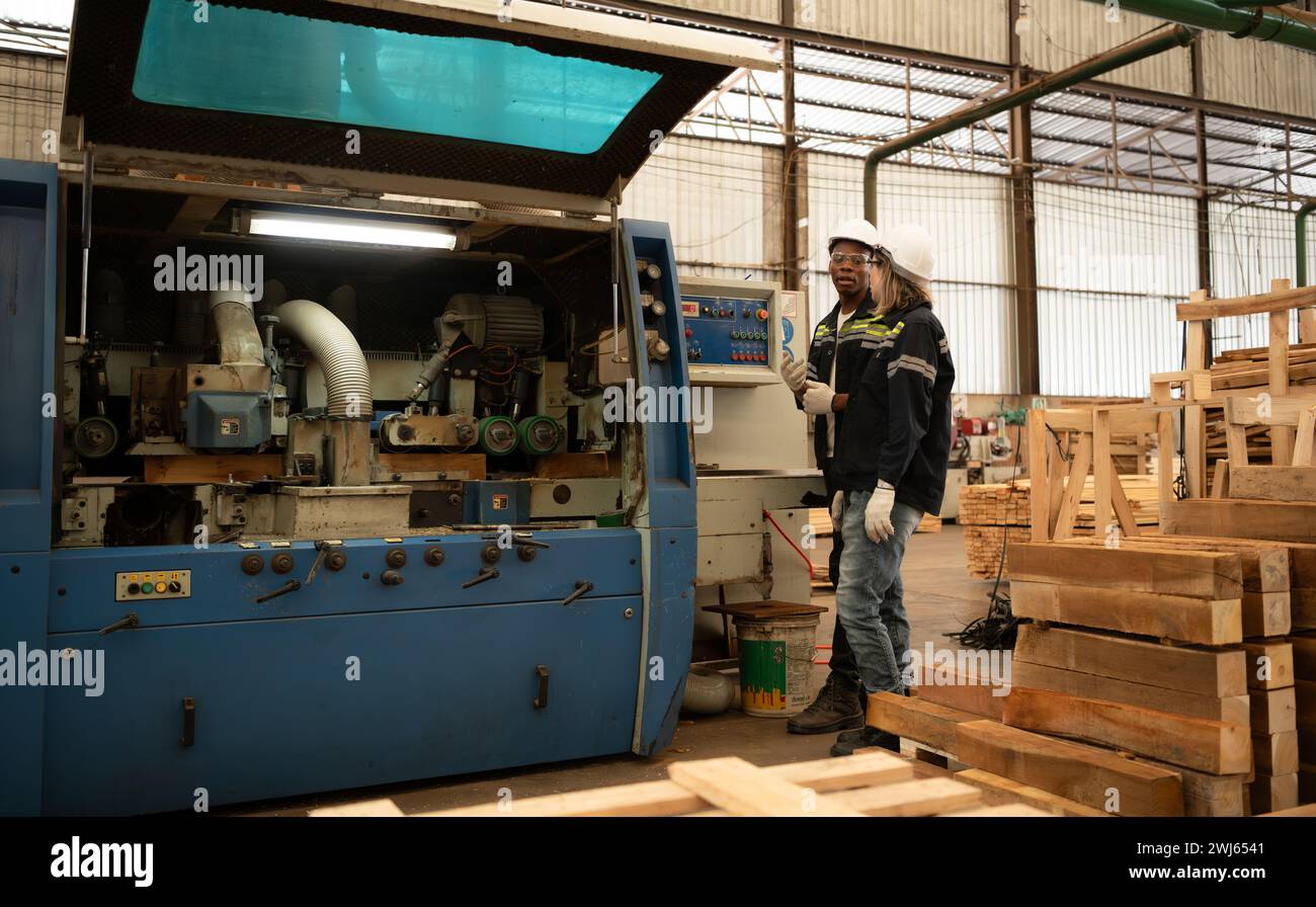 Both workers work in a woodworking factory, Working with wood sawing ...