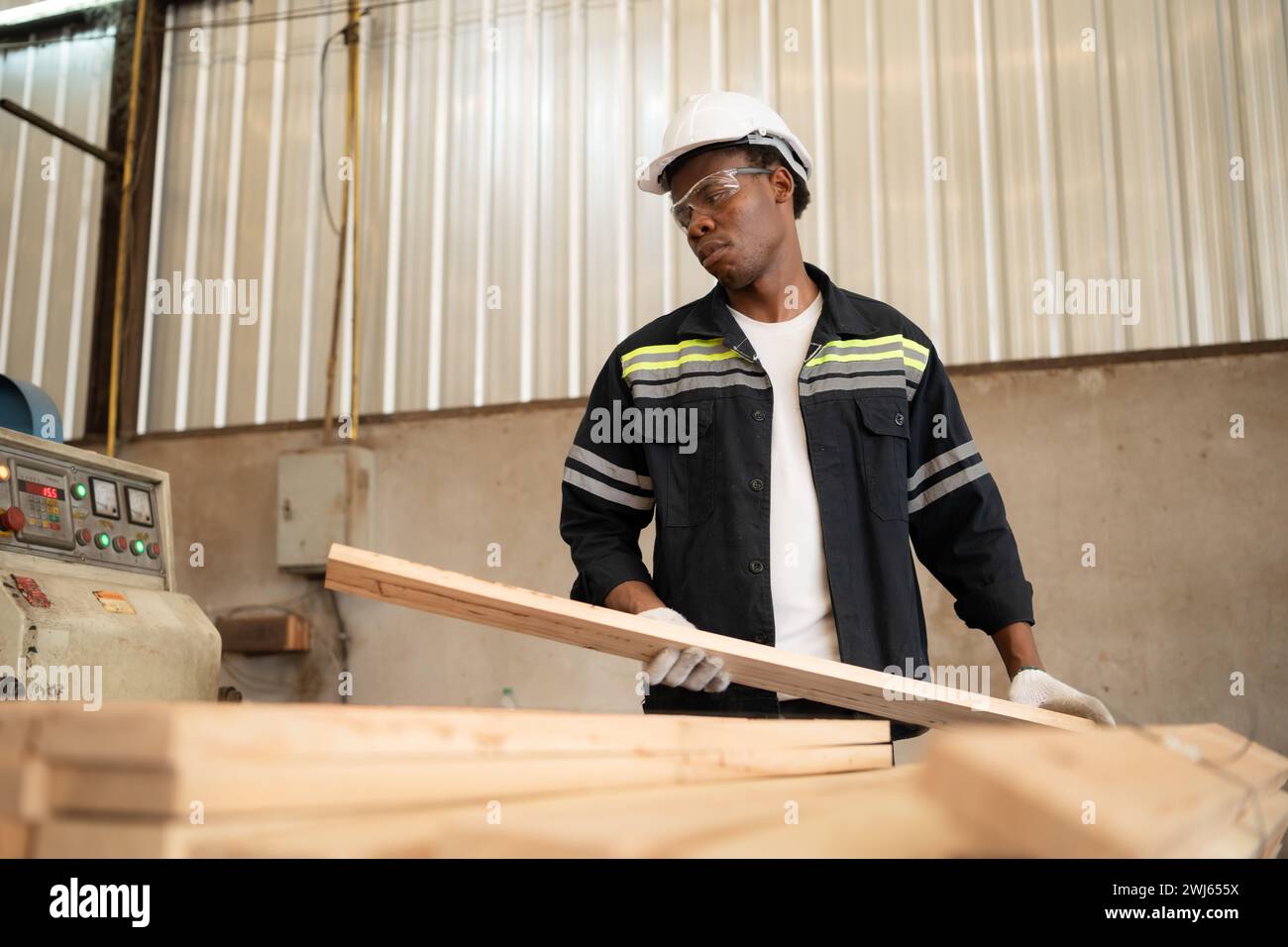 Young man worker work in a woodworking factory, Working with wood ...