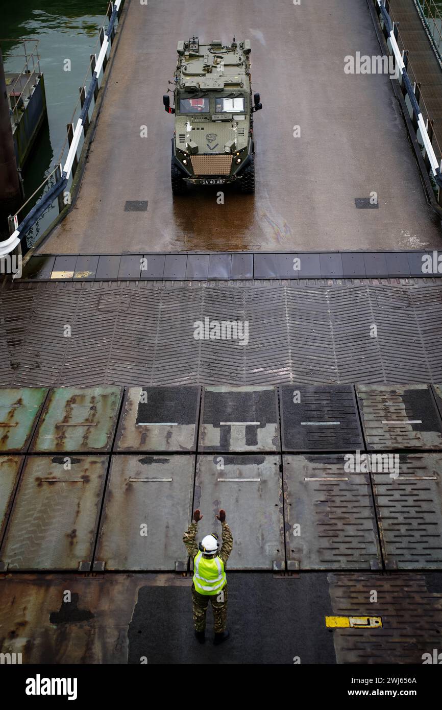 Vehicles and equipment are loaded onboard MV Anvil Point at the Sea ...